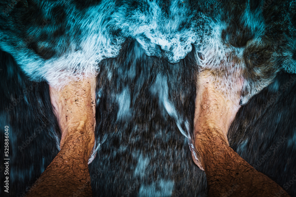 Artistic photo of abstract human feet, motion blur in water on charcoal ...