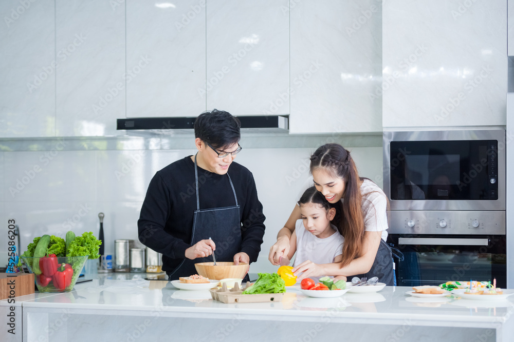Asian family cooking at home. Happy family cooks together in the ...