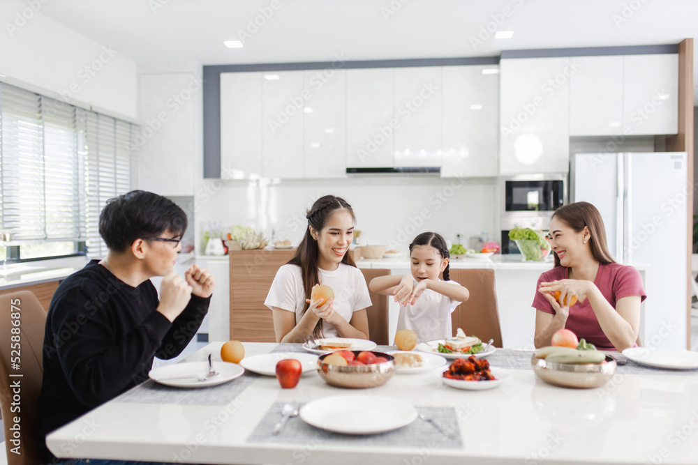 Happy Asian family dining at home. families enjoy together at home while having a meal at dining ...