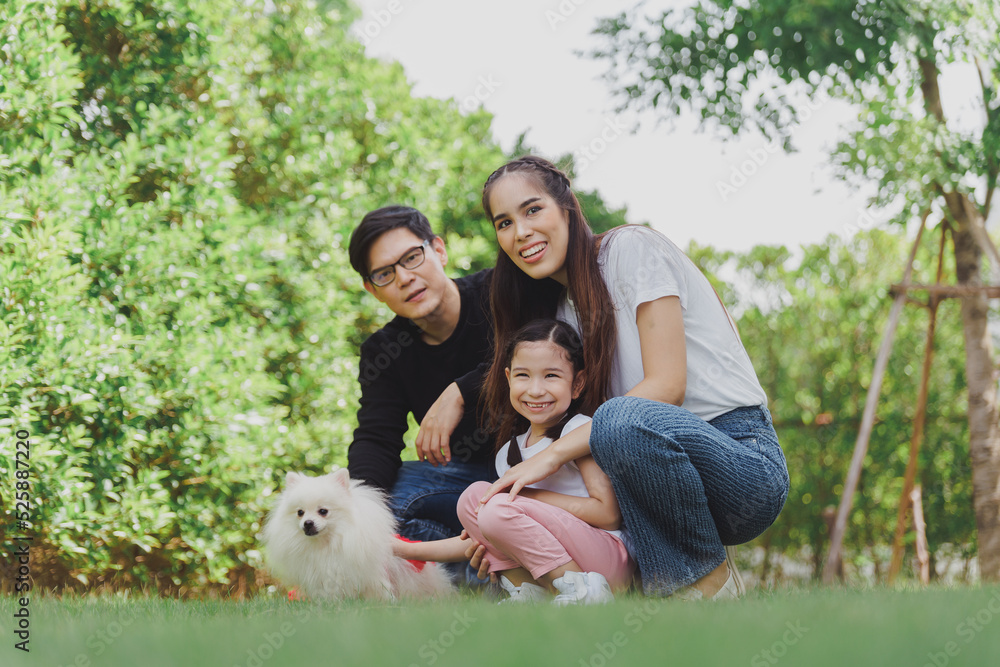 Asian Family with a child playing on a lawn, Family sitting on the ...
