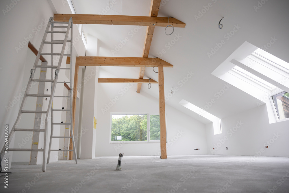 modern attic construction site freshly painted, the floor is still ...