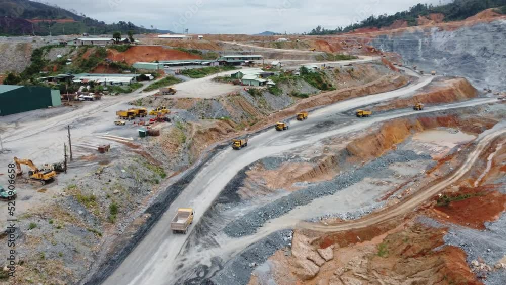 Excavator working at open pit mining on amazing sunset background ...