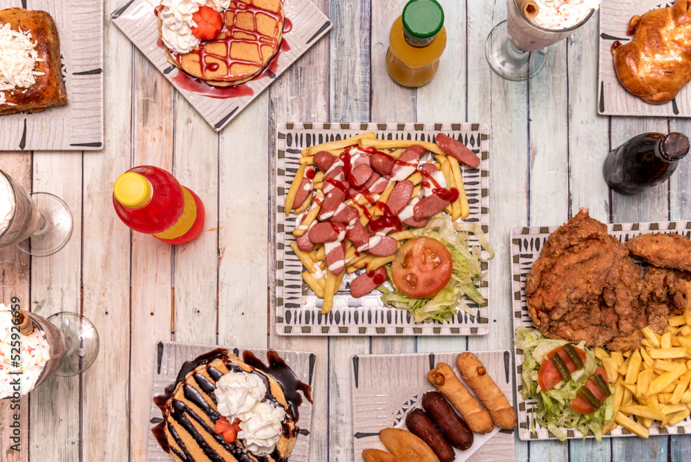 Set of fast food dishes with a tray of salchipapas, pancakes with ...