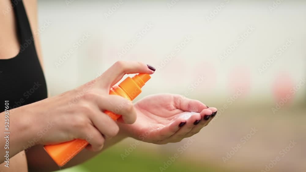 The process of applying sunscreen to the hand, a girl applies suntan ...