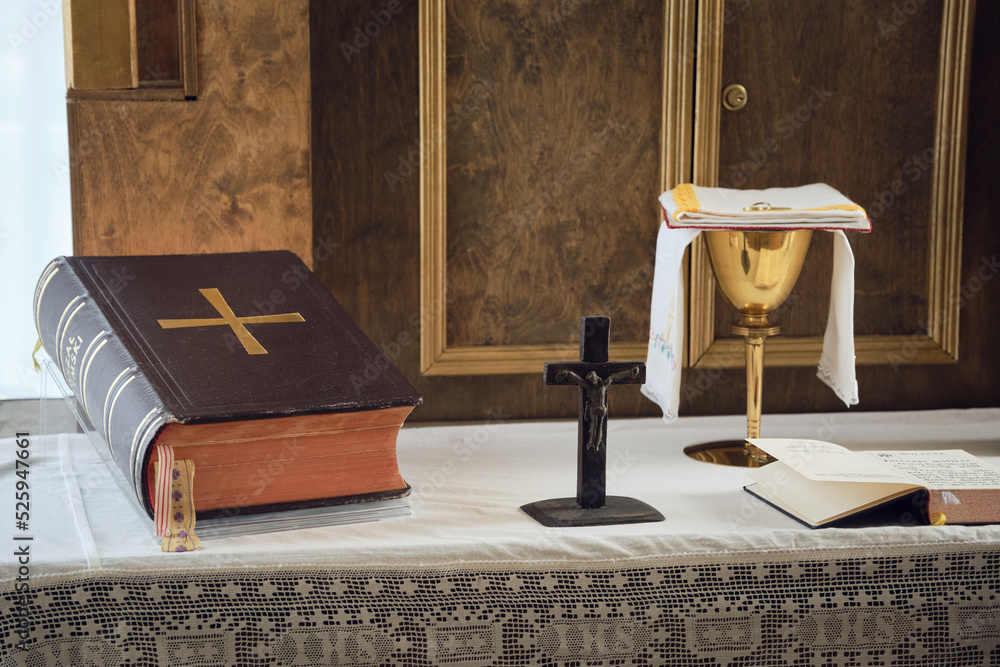Catholic symbols composition. The Bible, wooden cross and golden ...