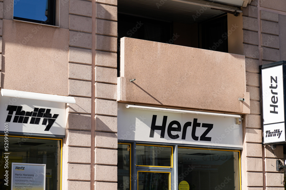 Hertz logo brand and text sign wall entrance of American car rental ...