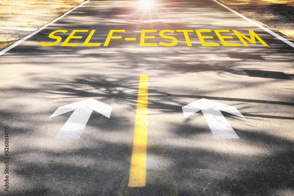 Self-esteem and arrow sign marking on road surface for giving ...