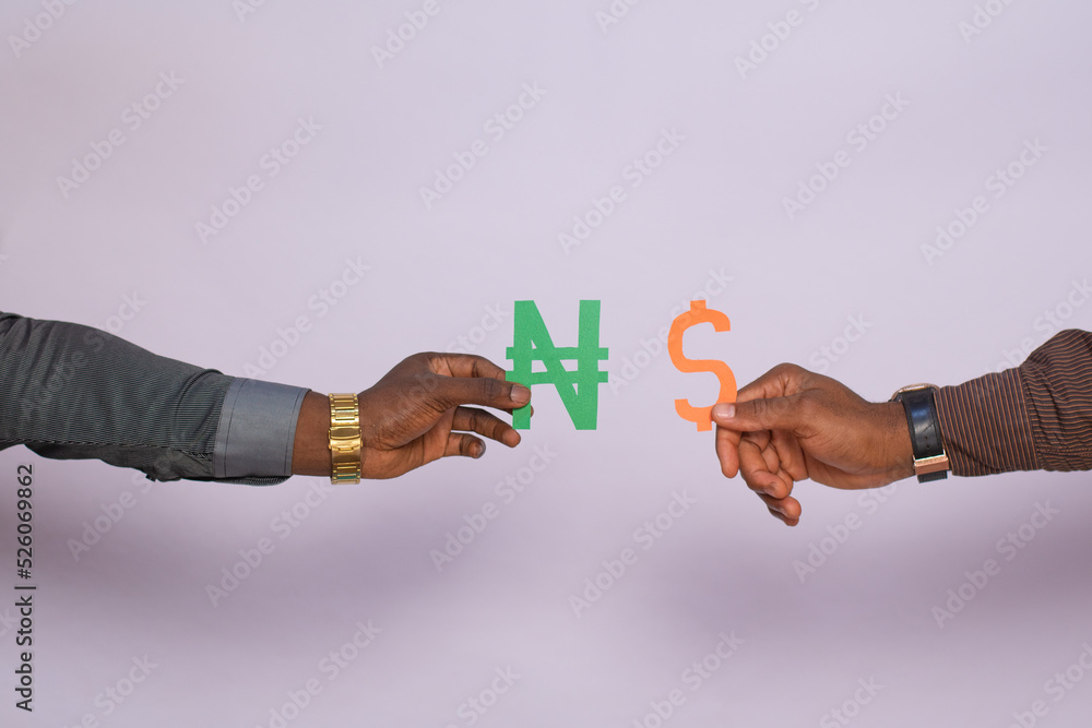 two black people holding naira and dollar symbols towards each other ...