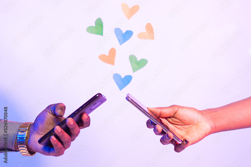 two black people using their phones with love shapes in the background ...