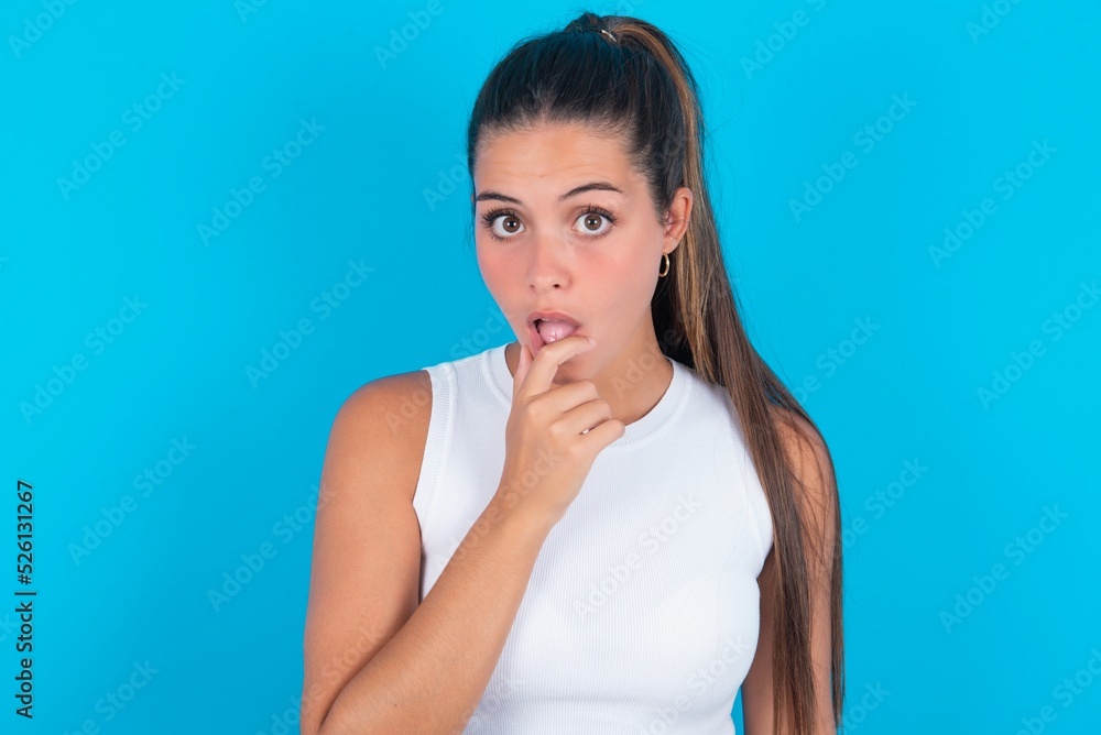 Nervous Puzzled Beautiful Brunette Woman Wearing White Tank Top Over