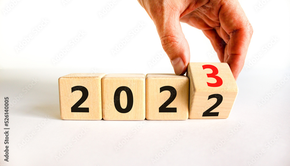 2023 happy new year symbol. Businessman turns cubes, symbolize the ...