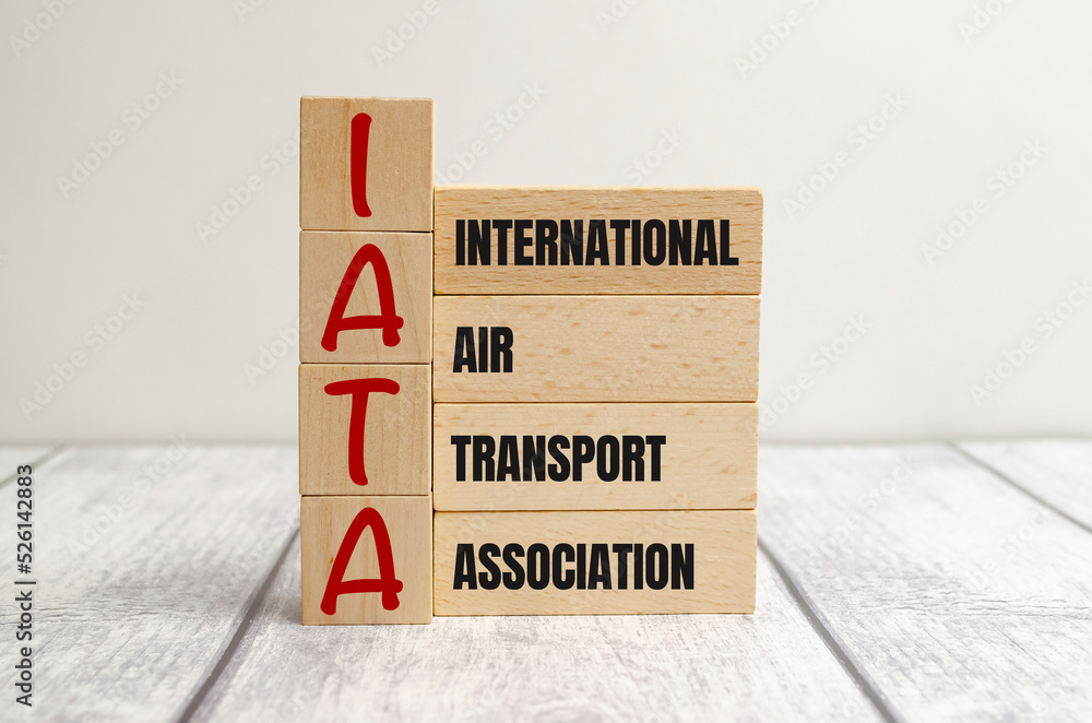 wooden cube block with IATA business word on table background. Mission ...