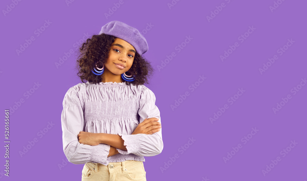 Portrait of smiling African American teen girl isolated on purple ...