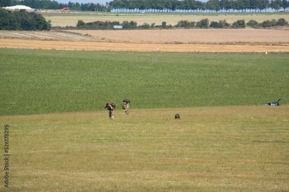 British army paratroopers move out from an overhead assault parachute ...