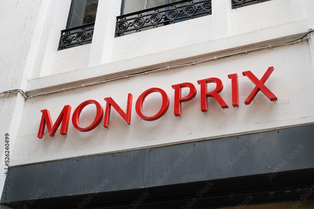 Monoprix logo brand and red sign text on wall entrance city shop ...