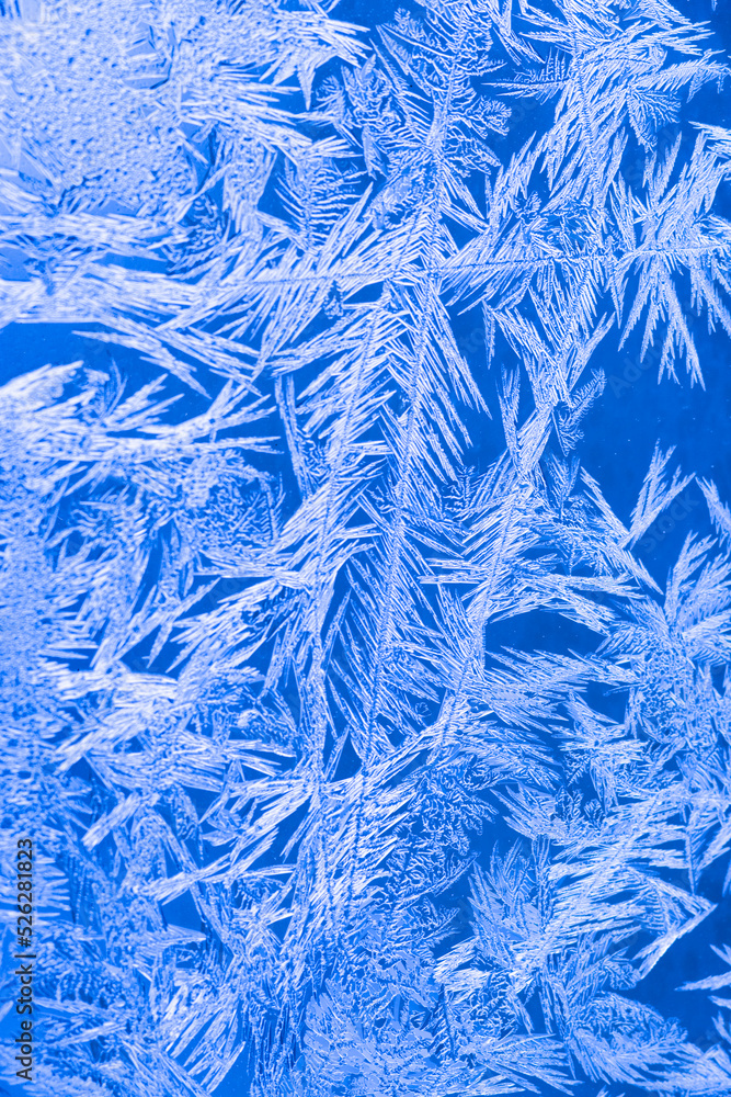 Frozen texture. Frost patterns on frozen window as a symbol of ...