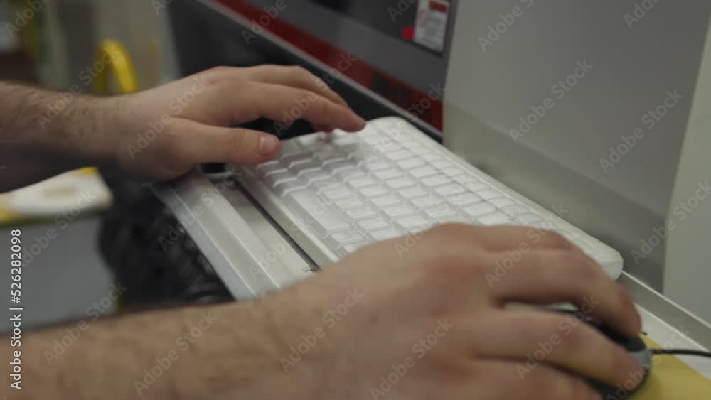 the operator adjusts the production process in the factory on the ...