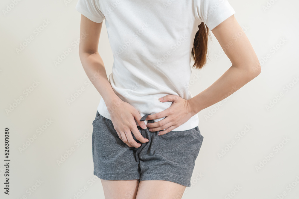 woman having painful lower stomach and hands holding pressing her ...