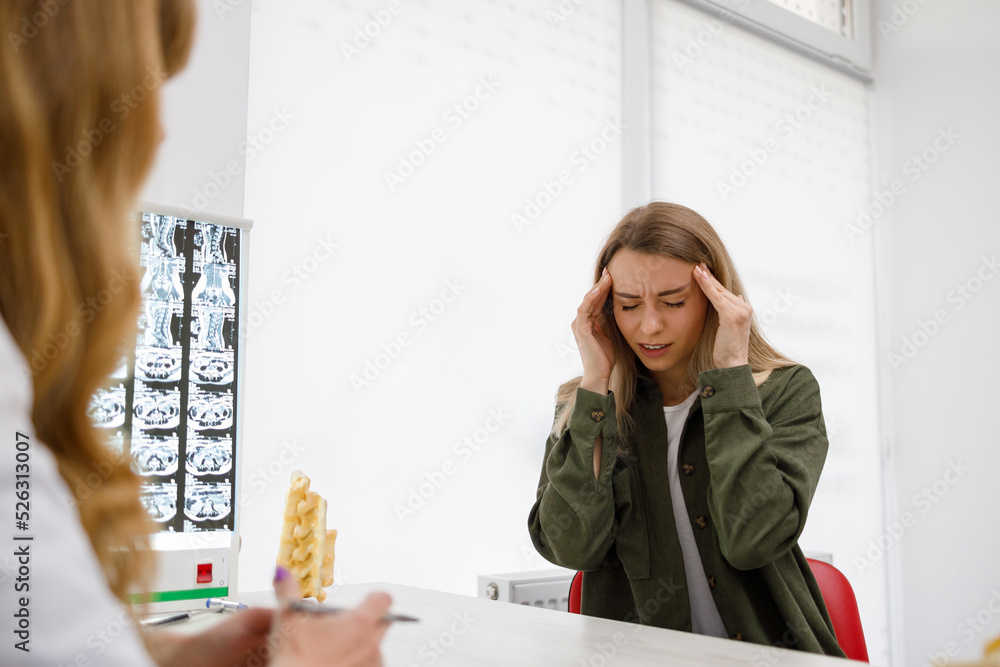 Female patient with acute headache at the doctor's examination. Please ...