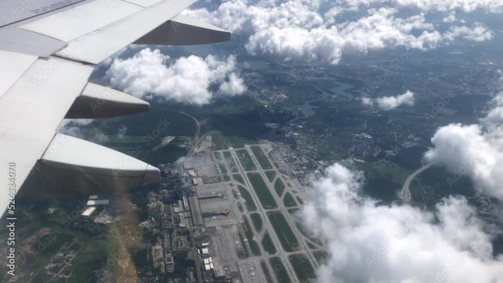 Cabin view of plane wing and airport runways and clouds Stock Video ...