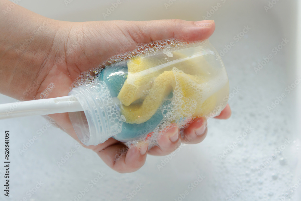 Washing baby bottle. Mother's hand washing the baby bottle.. Stock ...