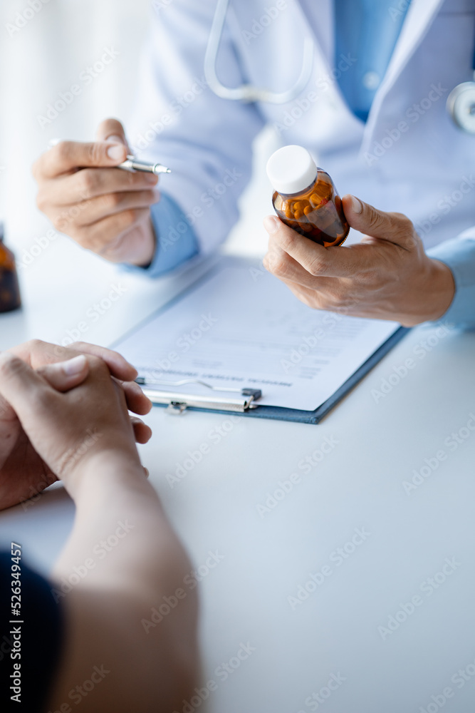 Doctor are recommending medicines to patients after being examined and ...