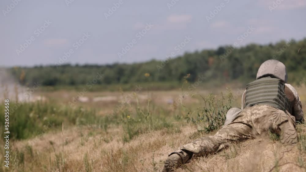 Defending the nation in a green uniform vest with a machine gun in hand ...