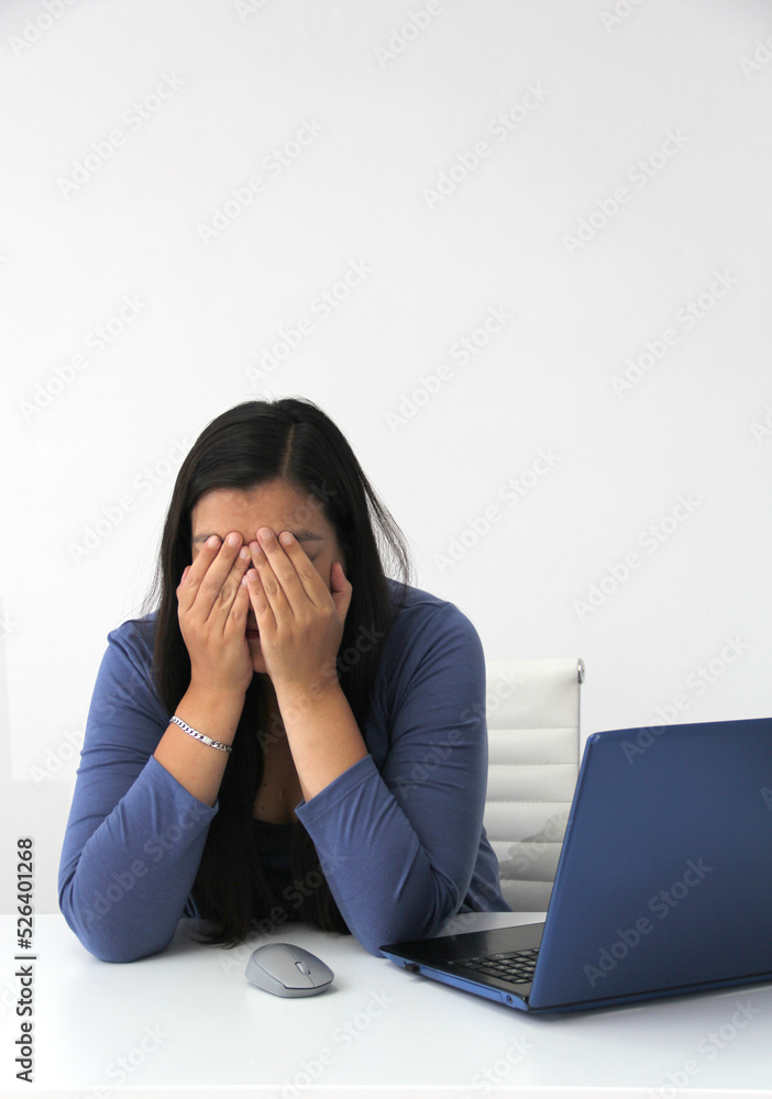 Dark-haired latin adult woman works in her office with laptop with a ...