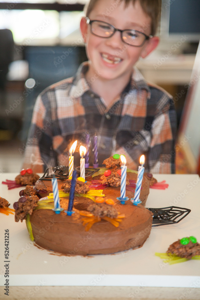 Child smiling behind number eight spider birthday cake Stock Photo ...