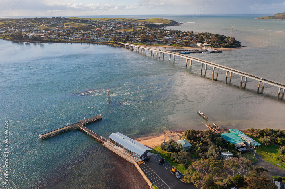 Aerial view of a jetty and narrow bridge linking the mainland to a ...