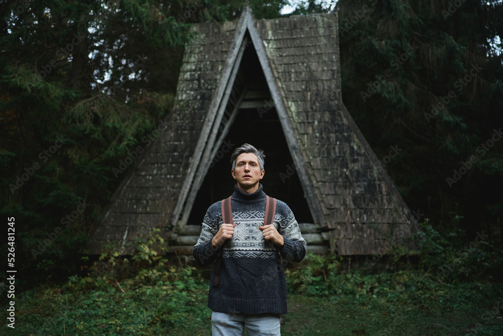 Stranger traveler man in ethnic sweater alone standing in front of old ...