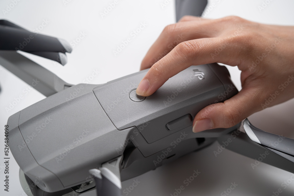 PENANG, MALAYSIA - JUL 08, 2020: Hand pressing the power button of the ...