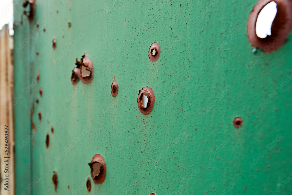 Gate riddled with bullets. Traces of bullets and fragments of shells ...