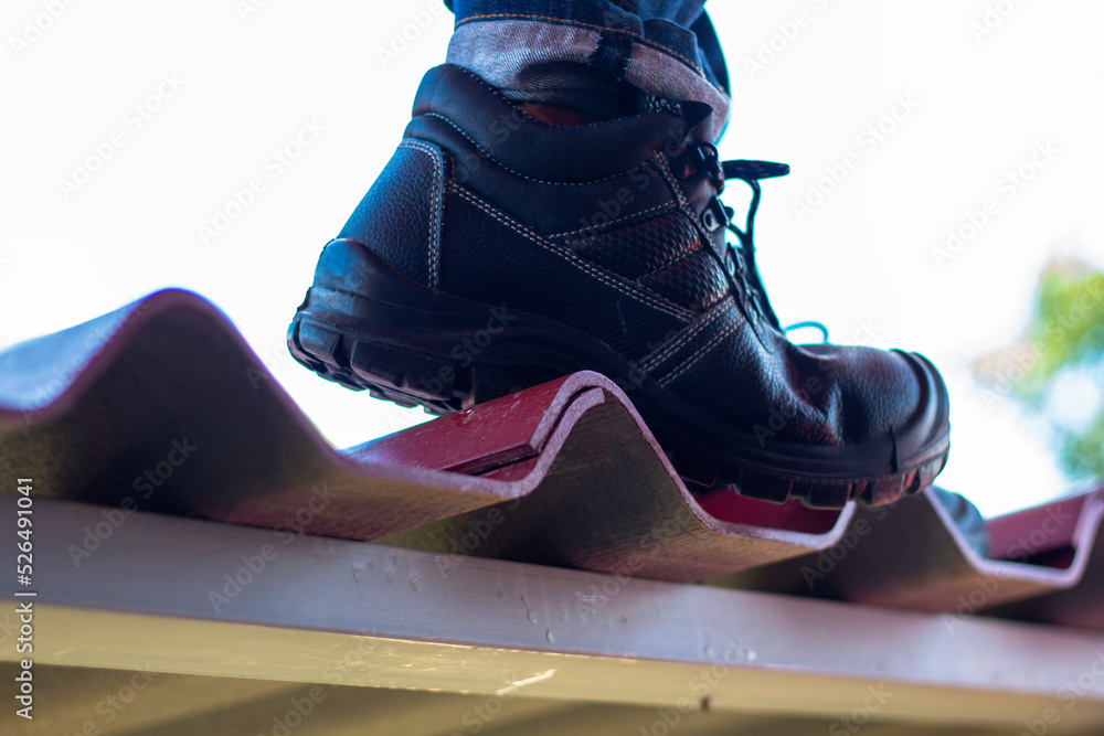 Wear safety shoes to ensure safety at work. construction workers wear ...