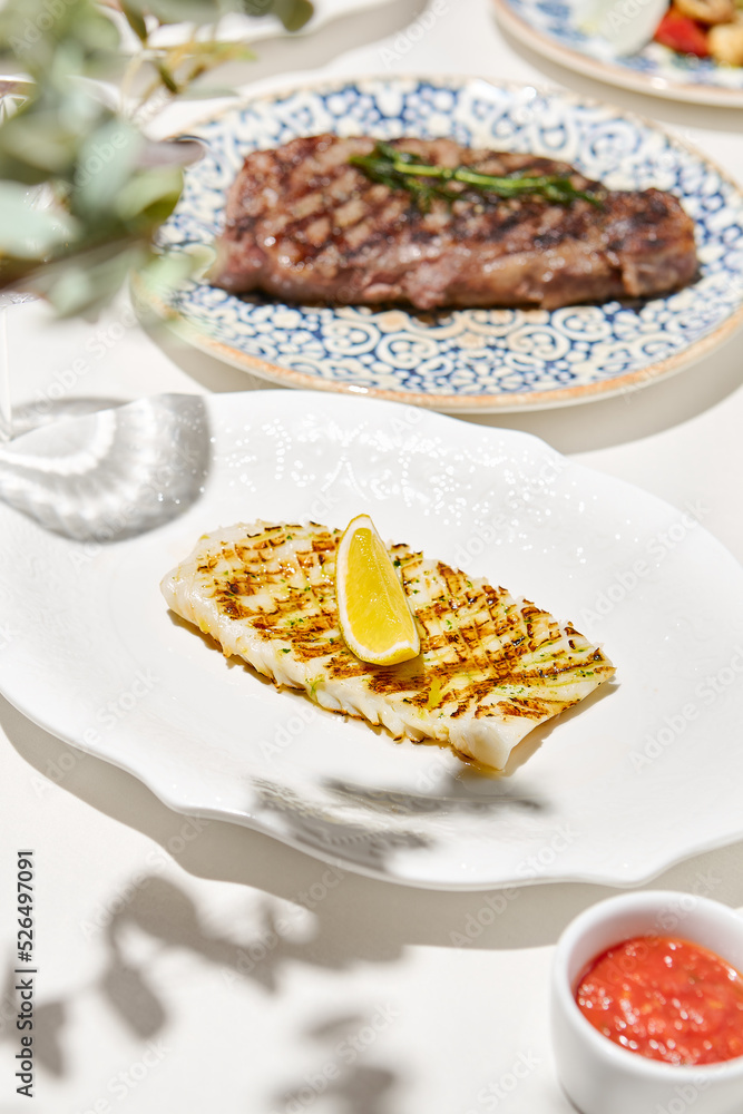 Grilled calamari on light background with shadows. Grilled squid with ...