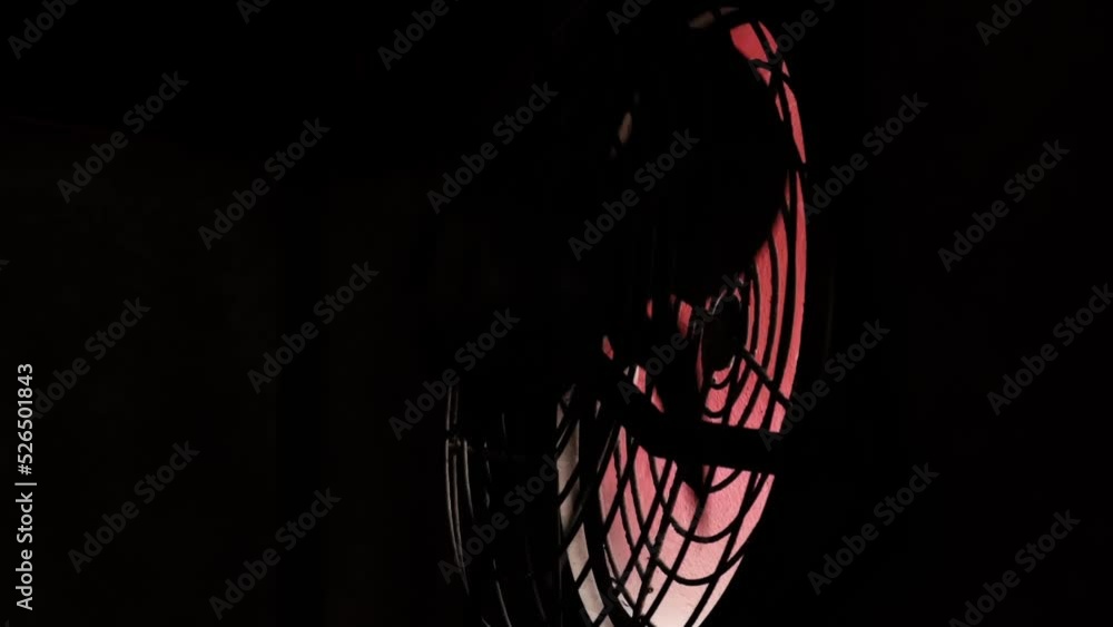 Video „Slow-motion close-up footage of a rotating fan bladder in a dark ...