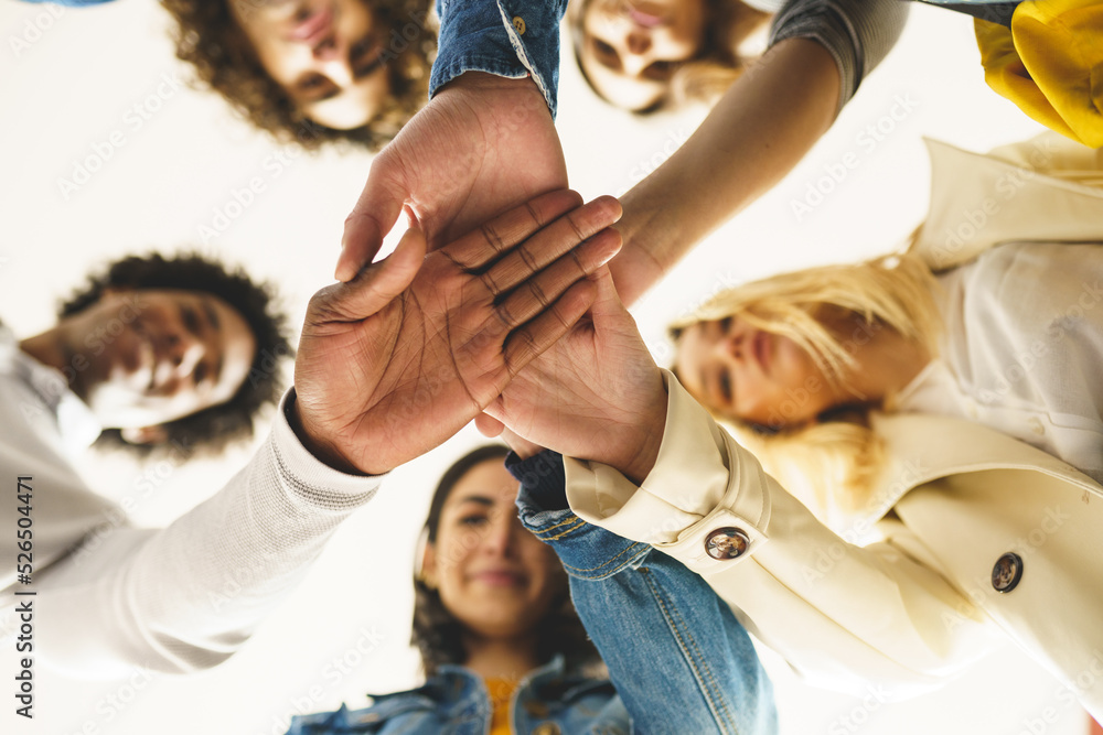 Diverse people stacking hands together Stock Photo | Adobe Stock