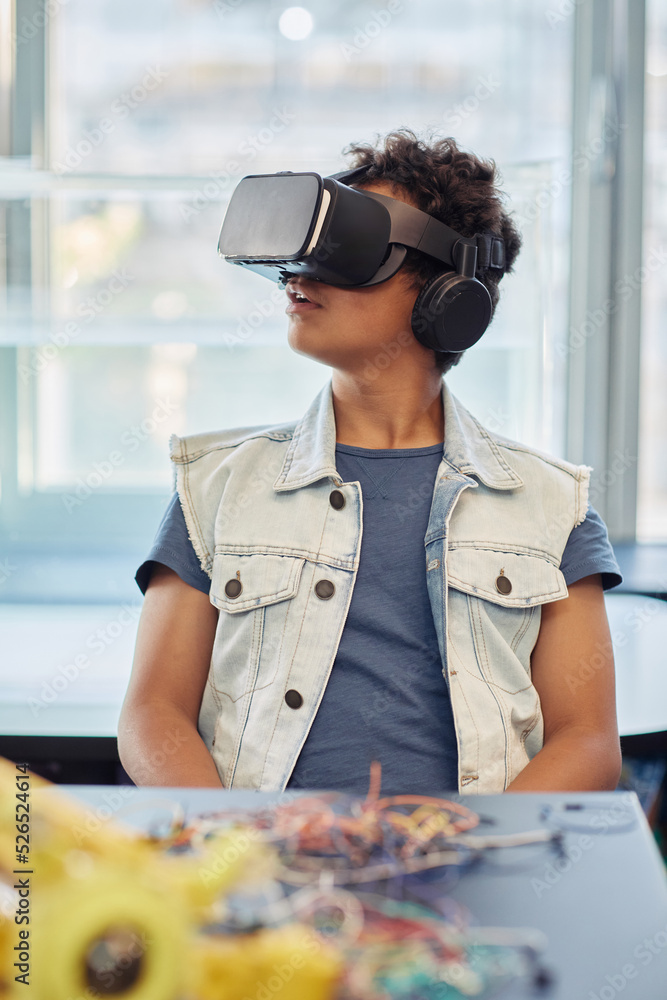 Vertical portrait of black teenage boy using VR technology in ...