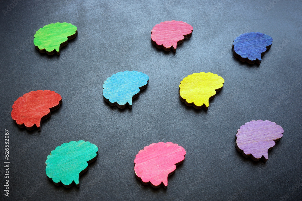 Neurodiversity concept. Multi-colored figures of the brain on a dark ...