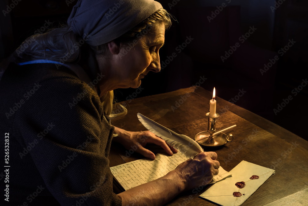 Woman at vintage desk writing a letter with a feather quill Stock Photo ...