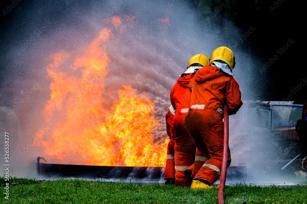 Firefighter Concept. Fireman using water and extinguisher to fighting ...