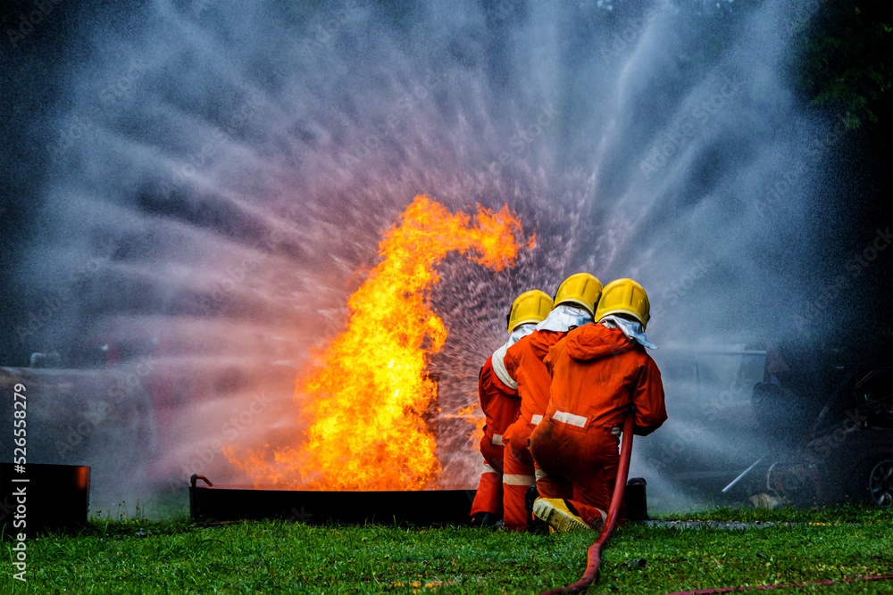 Firefighter Concept. Fireman using water and extinguisher to fighting ...