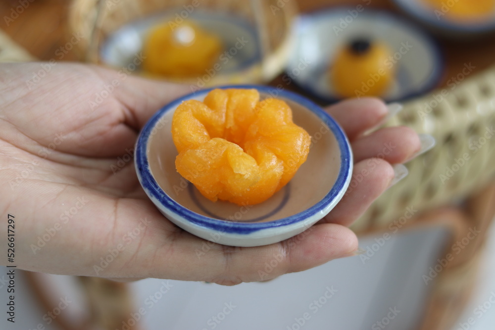 Hand holding Thong Yip recipe also known as pinched gold egg yolks ...