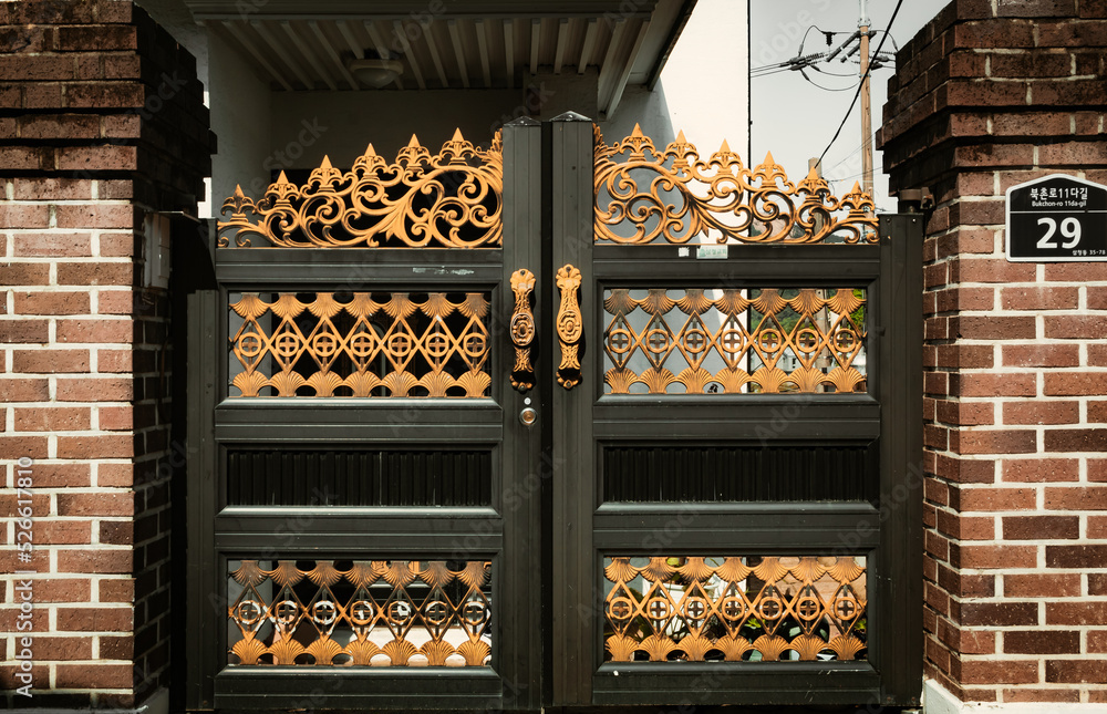 Gold and black entry gate at the Bukchon korean traditional hanok ...