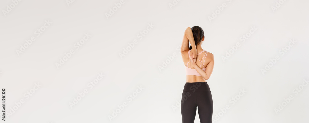 Full length rear view of active and slim brunette asian fitness girl ...