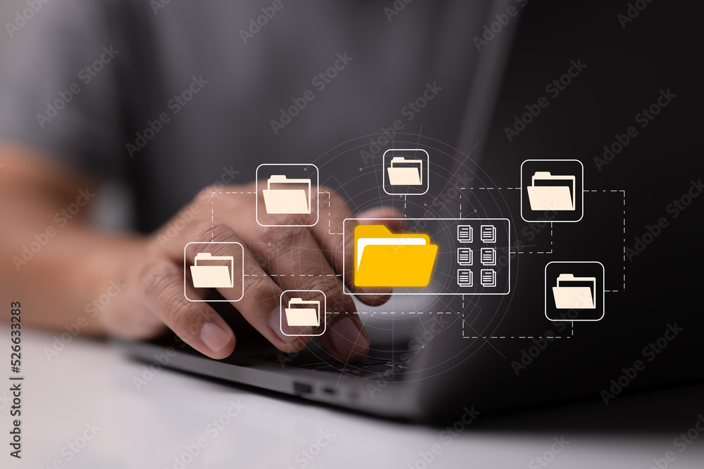 E-documents enable paperless offices. A businessman types on a laptop ...