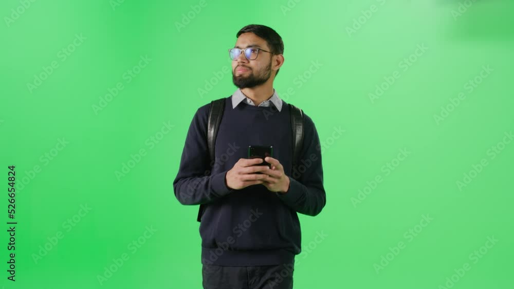 Green Screen Background: Handsome Asian Man Walks, Uses Smartphone. Guy ...