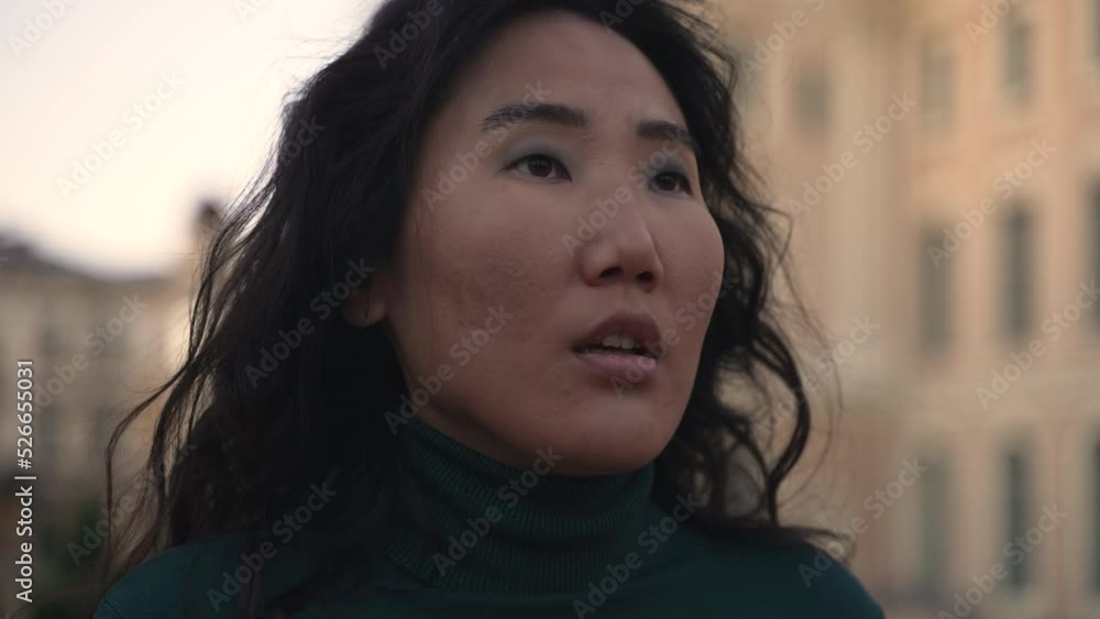 4k Portrait of young woman is showing fear and running away along city ...