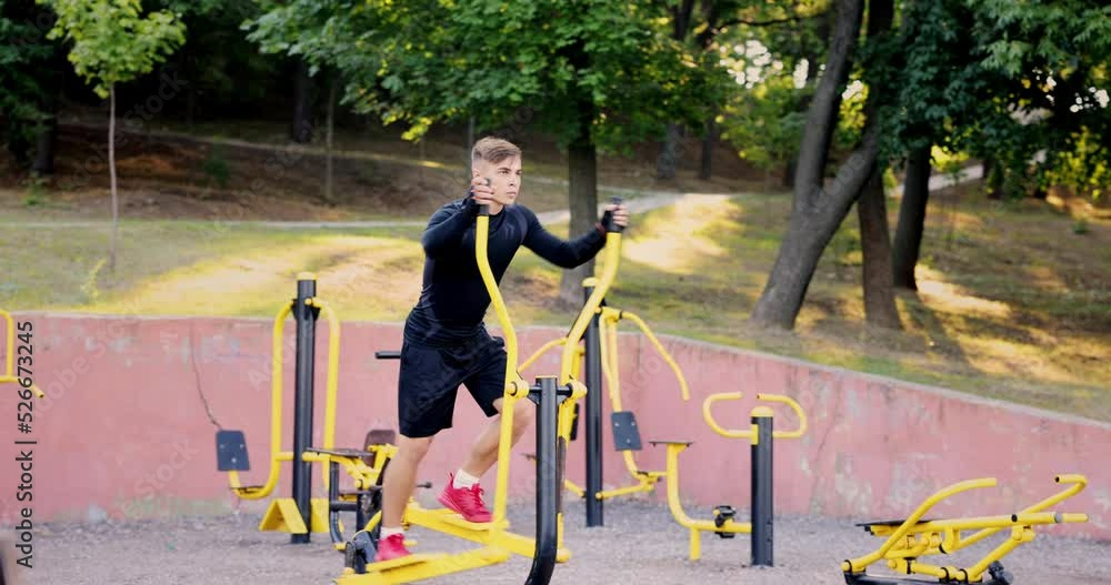 Boy performs exercises on a leg trainer, running and walking, stepper ...