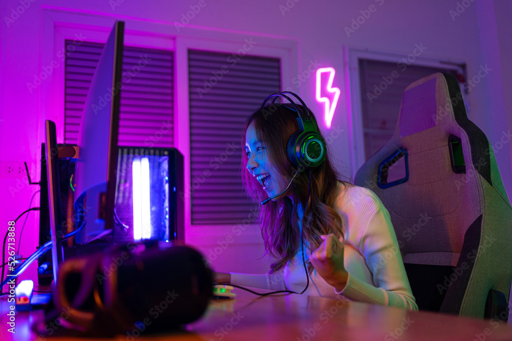 Asian gamer playing online video game winning excited on PC with ...